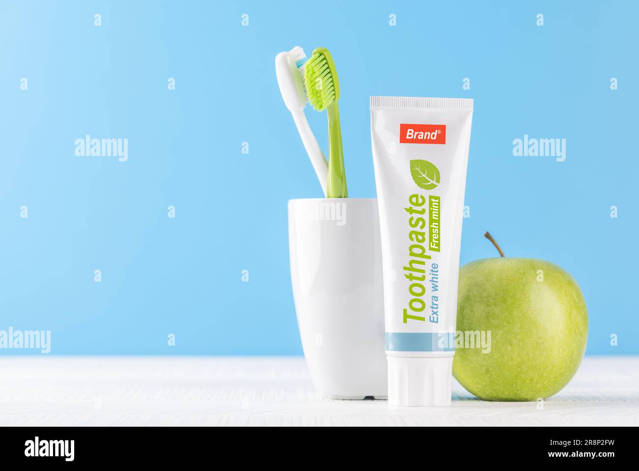 A clean and refreshing image featuring toothpaste and toothbrushes ...