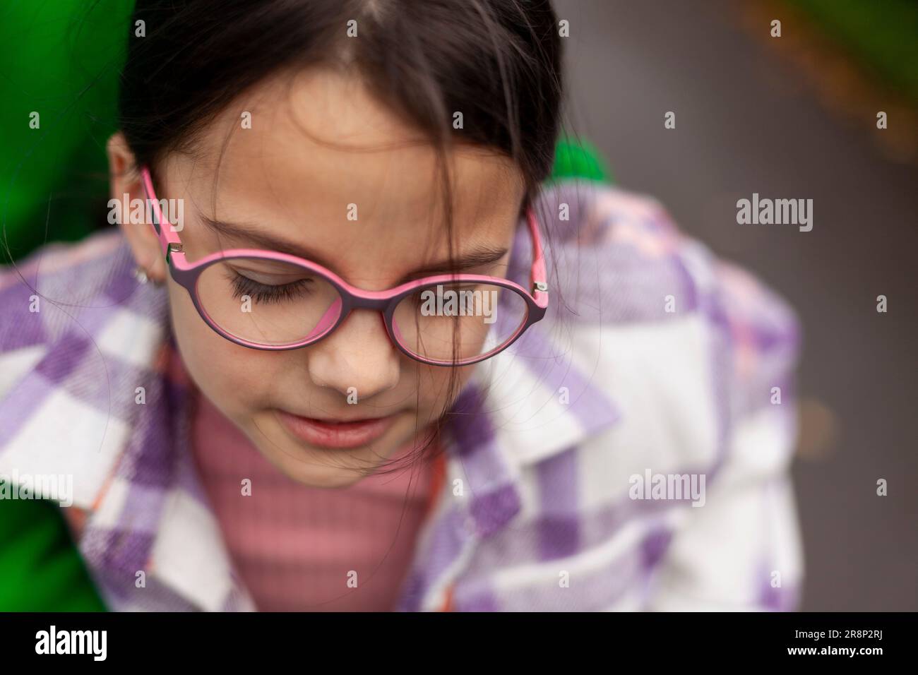 Portrait of a cute little girl wearing glasses and a plaid Stock Photo ...