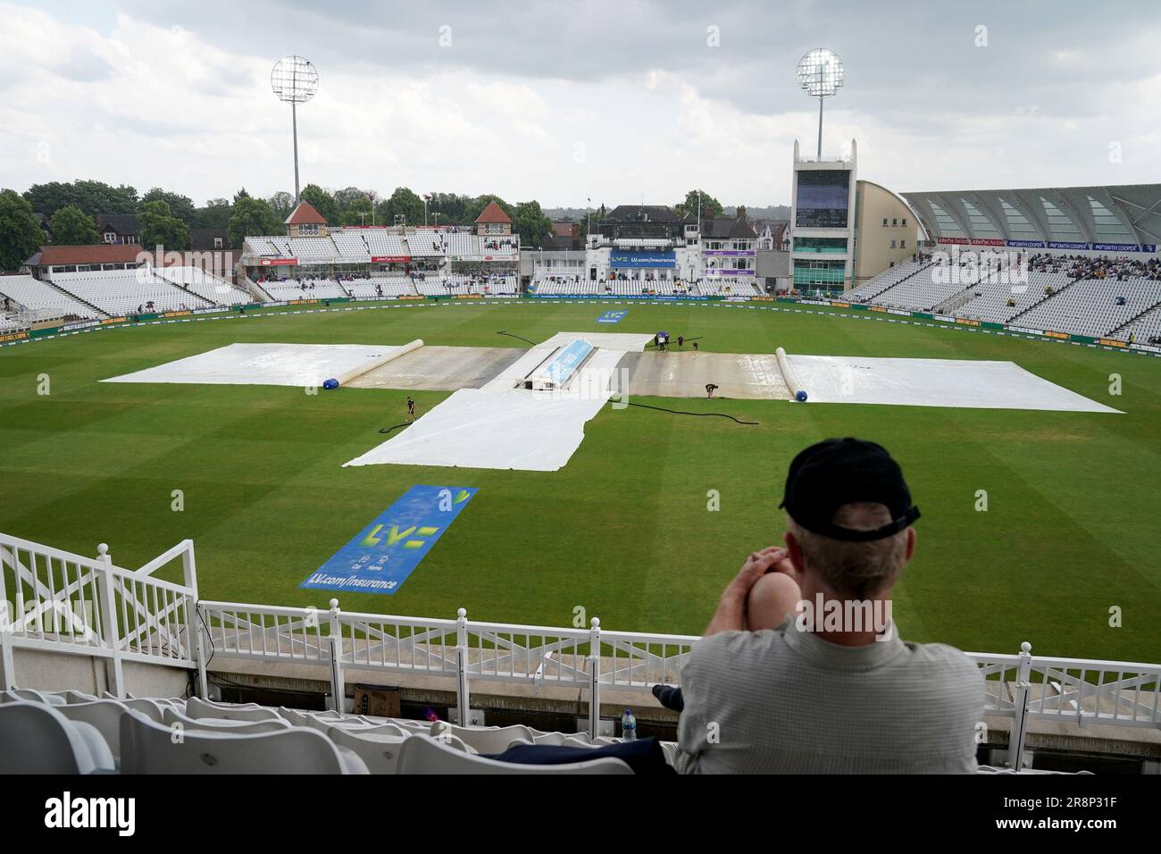 A view of the rain covers on the wicket as rain stops play during day ...