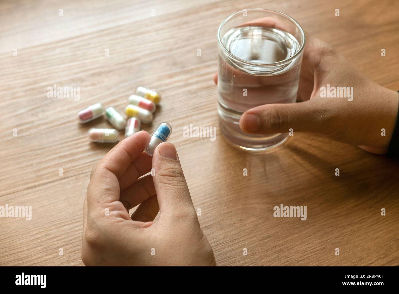 People taking medicine with a glass of drinking water Stock Photo - Alamy