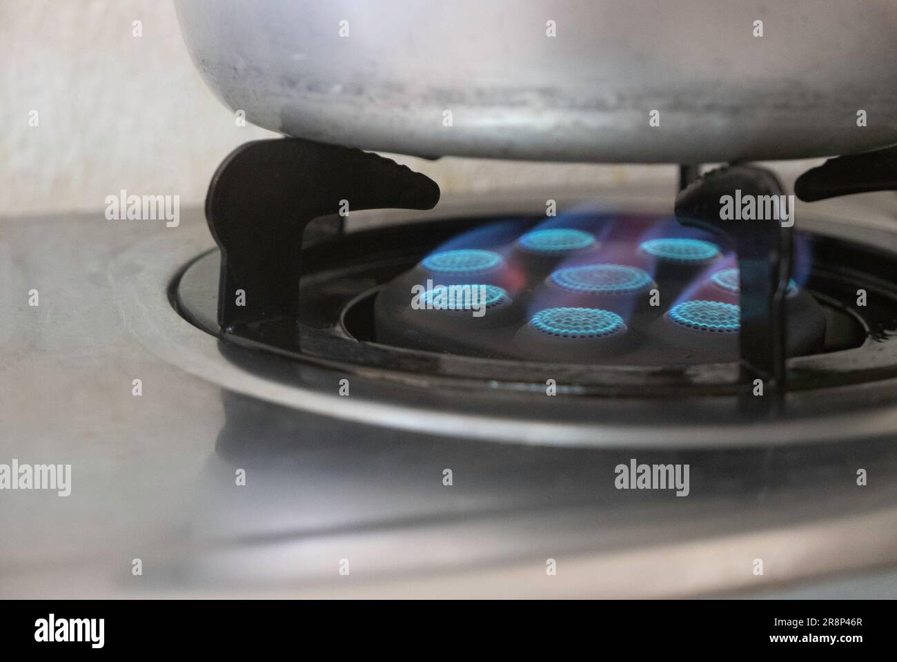 A blue fire from domestic kitchen stove.Gas cooker with burning flames ...