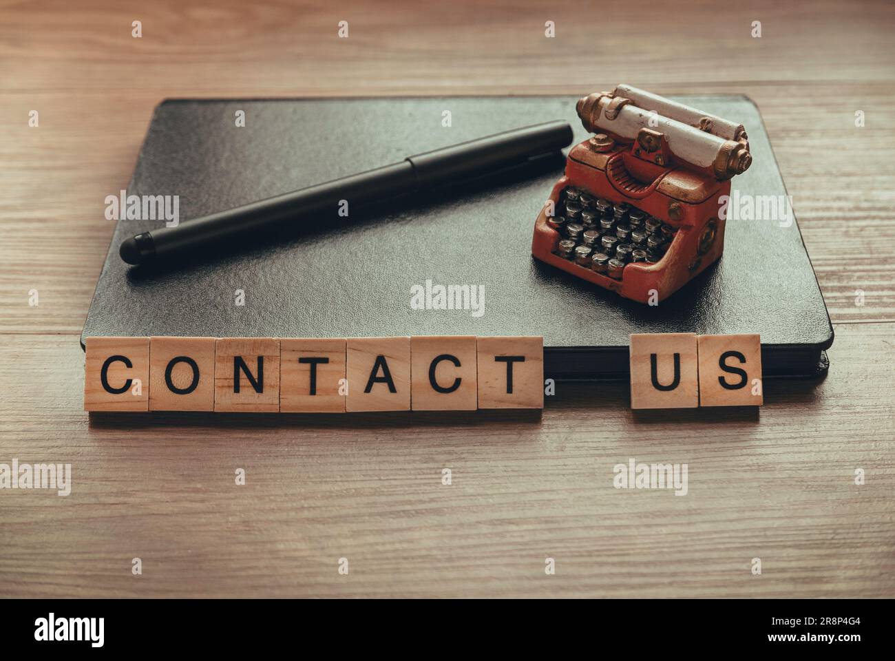 Contact us concept with notebook,pen and toy typewriter Stock Photo - Alamy