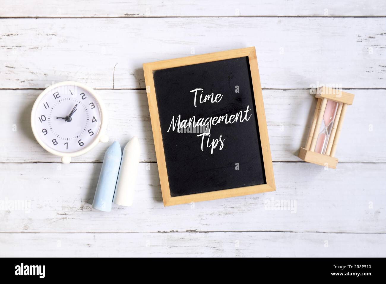 Top view of chalk,table clock,hourglass and blackboard written with ...