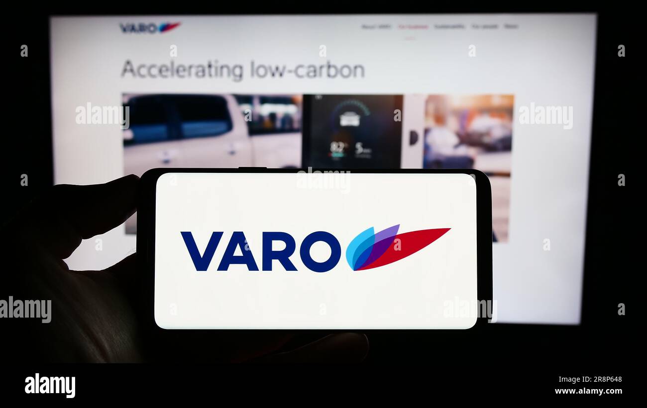 Person holding cellphone with logo of Swiss company VARO Energy ...