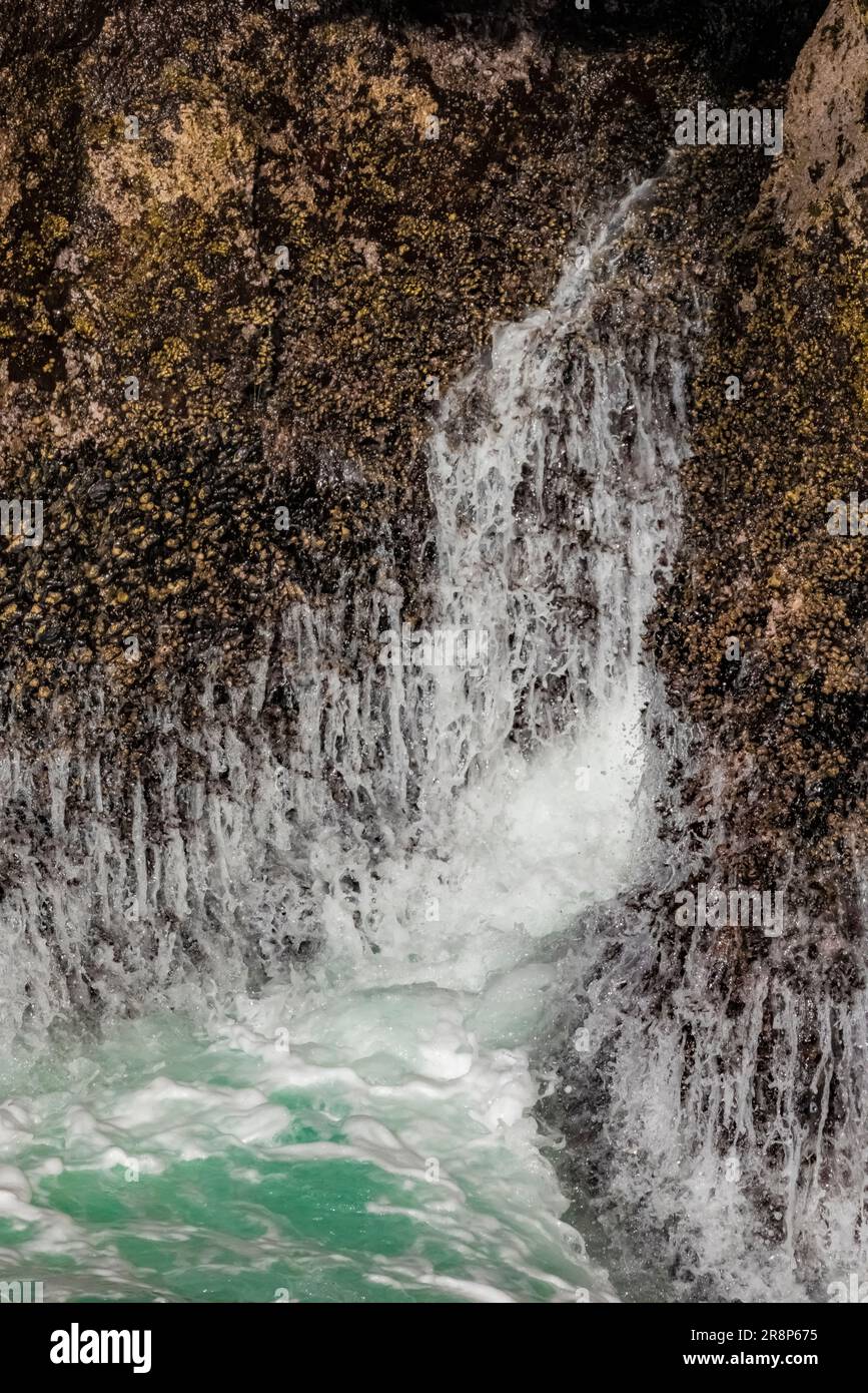 Seawater draining from cliffs after a crashing wave, Cape Flattery Trail, Makah Nation ...