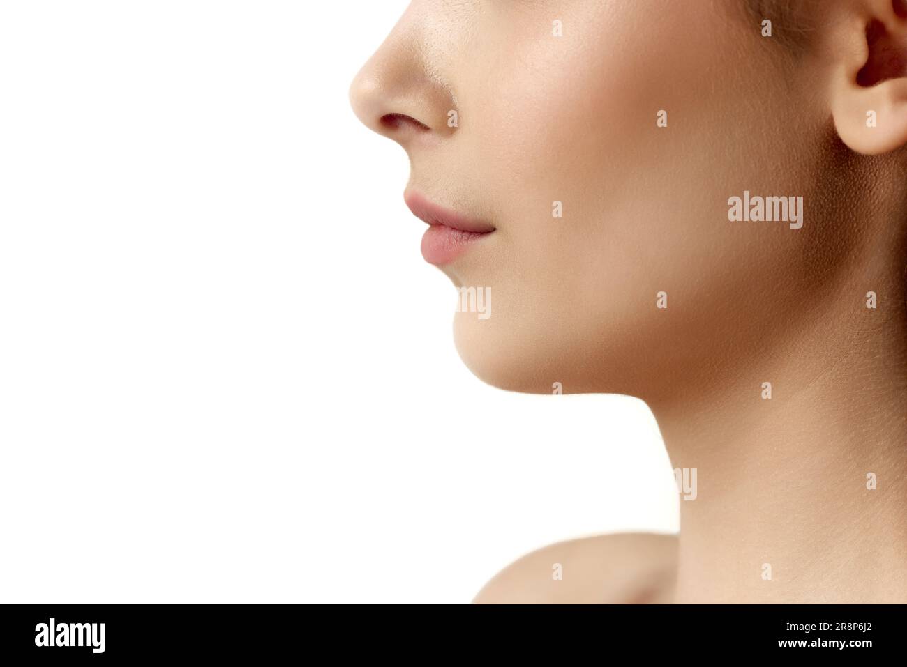 Close-up cropped profile image of female face part, chin, lips and nose ...
