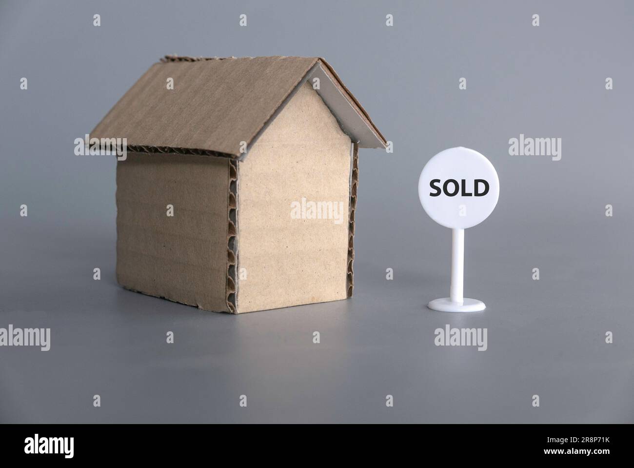 Real estate and property concept with a cardboard house and sold ...
