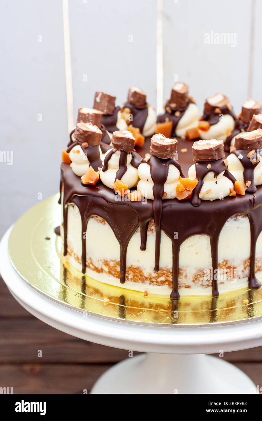Twix inspired cake with melted chocolate, cookies, salted caramel and ...