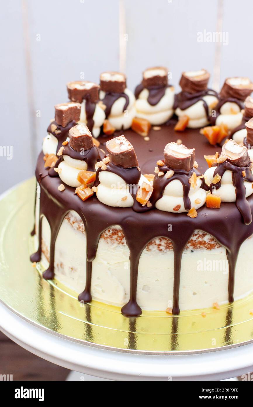 Twix inspired cake with melted chocolate, cookies, salted caramel and ...