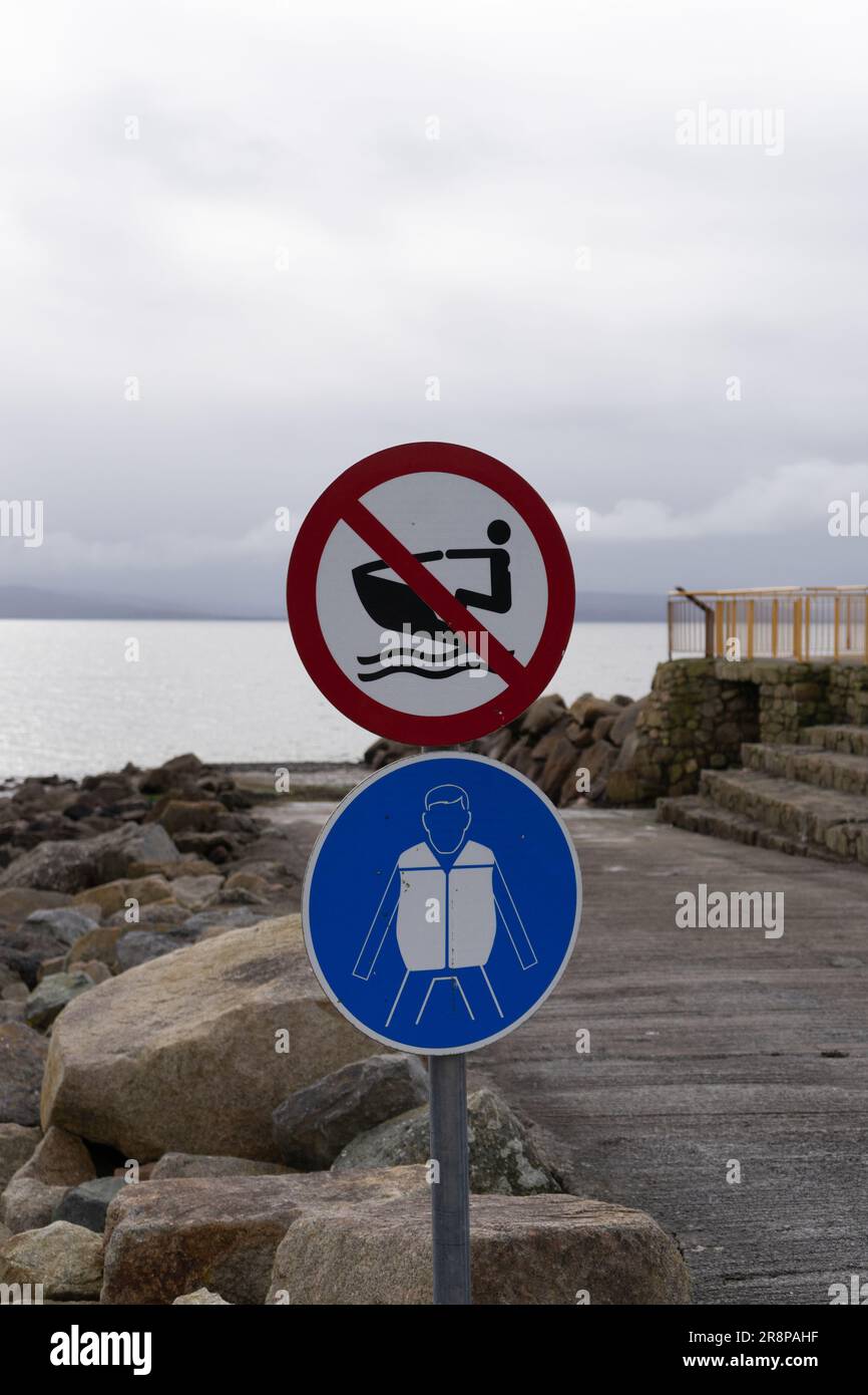 A beach pole with signs. Salthill Prom, Galway, Ireland. Water scooter ...