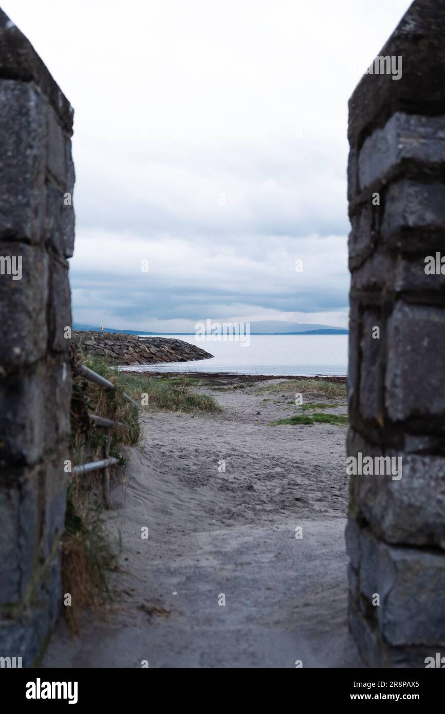 The empty beach and sea seen through stone walls Stock Photo - Alamy