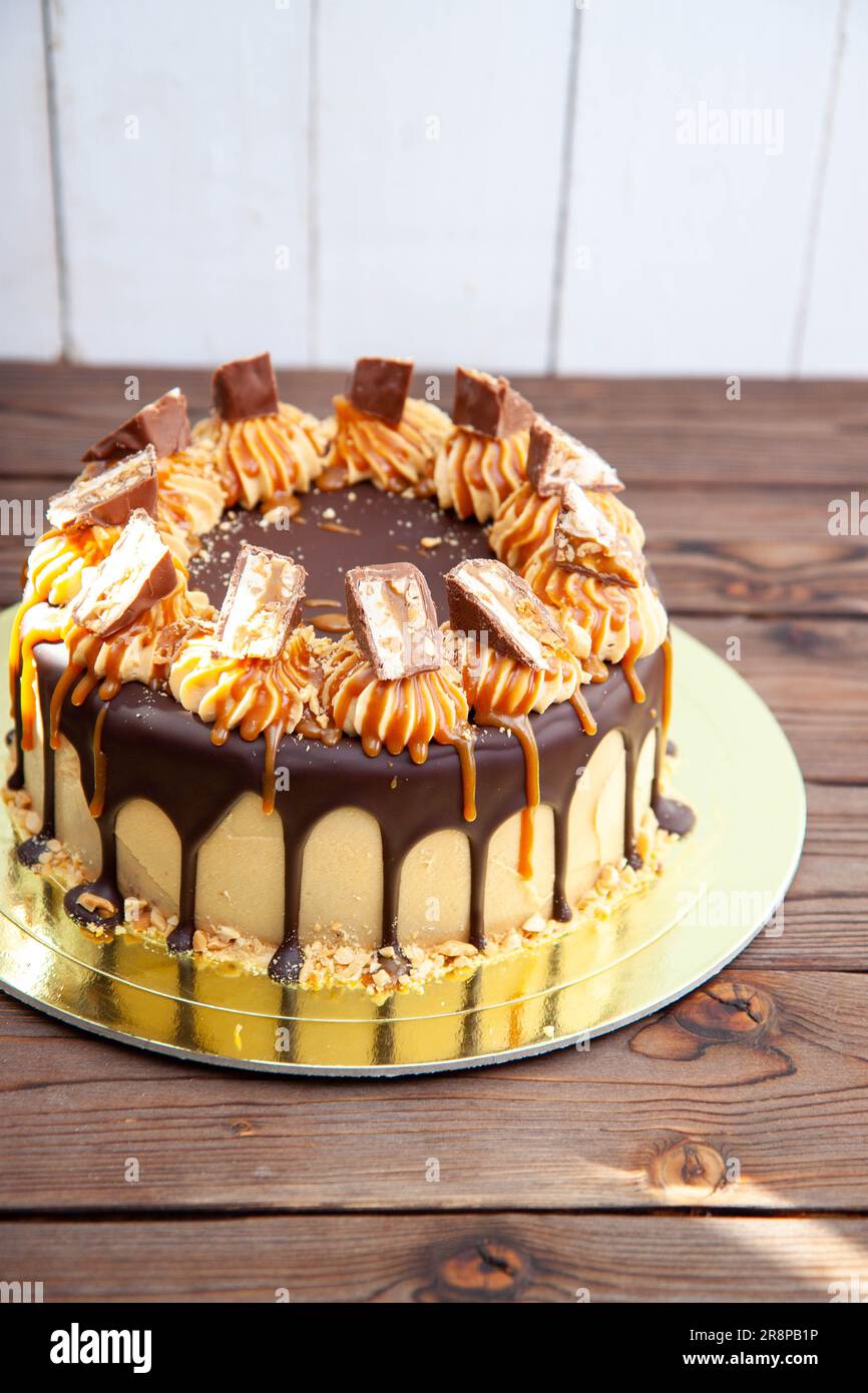 Gorgeous snickers cake with peanut butter cream, melted chocolate ...