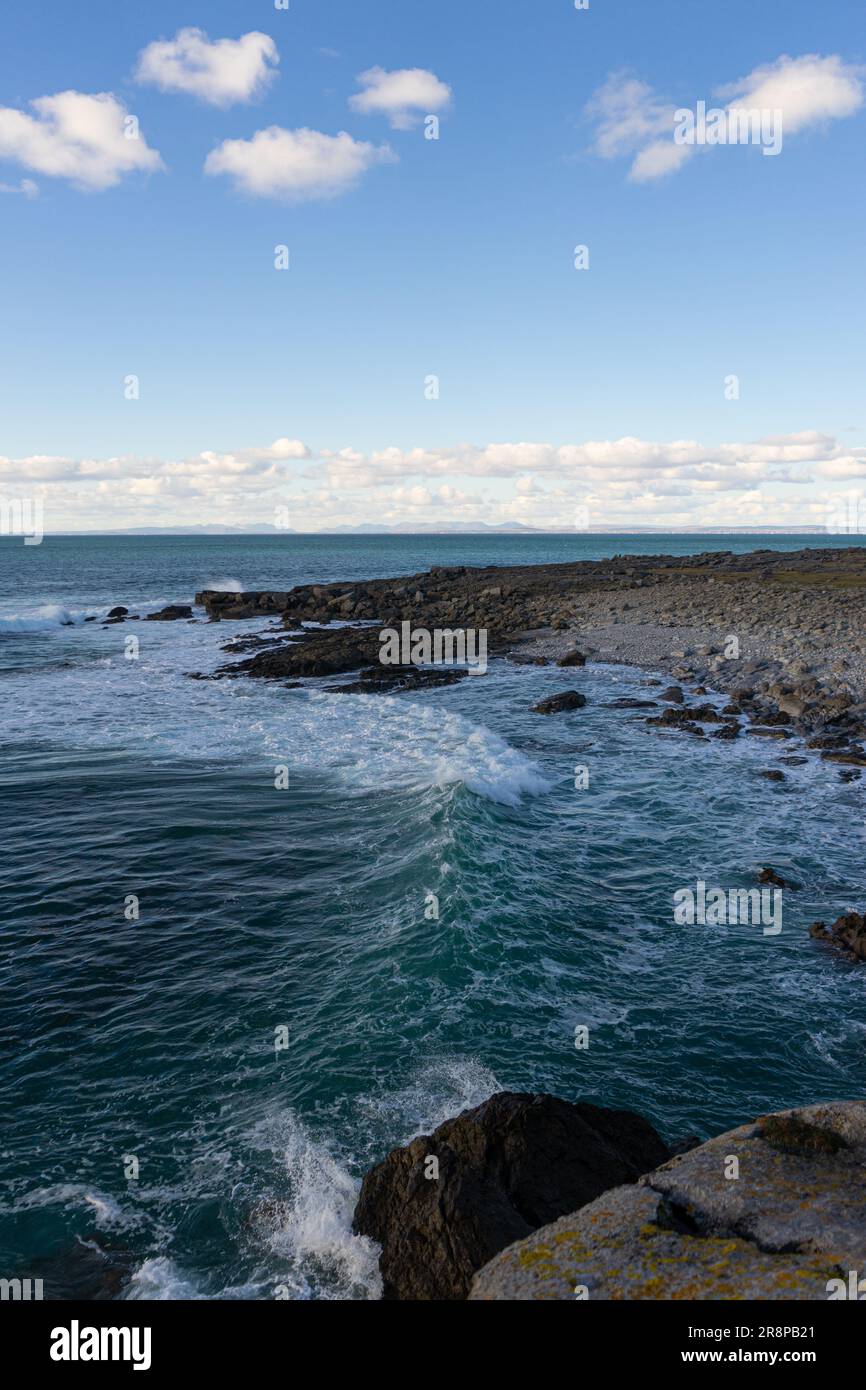 A scenic landscape featuring a tranquil blue ocean meeting a rocky ...
