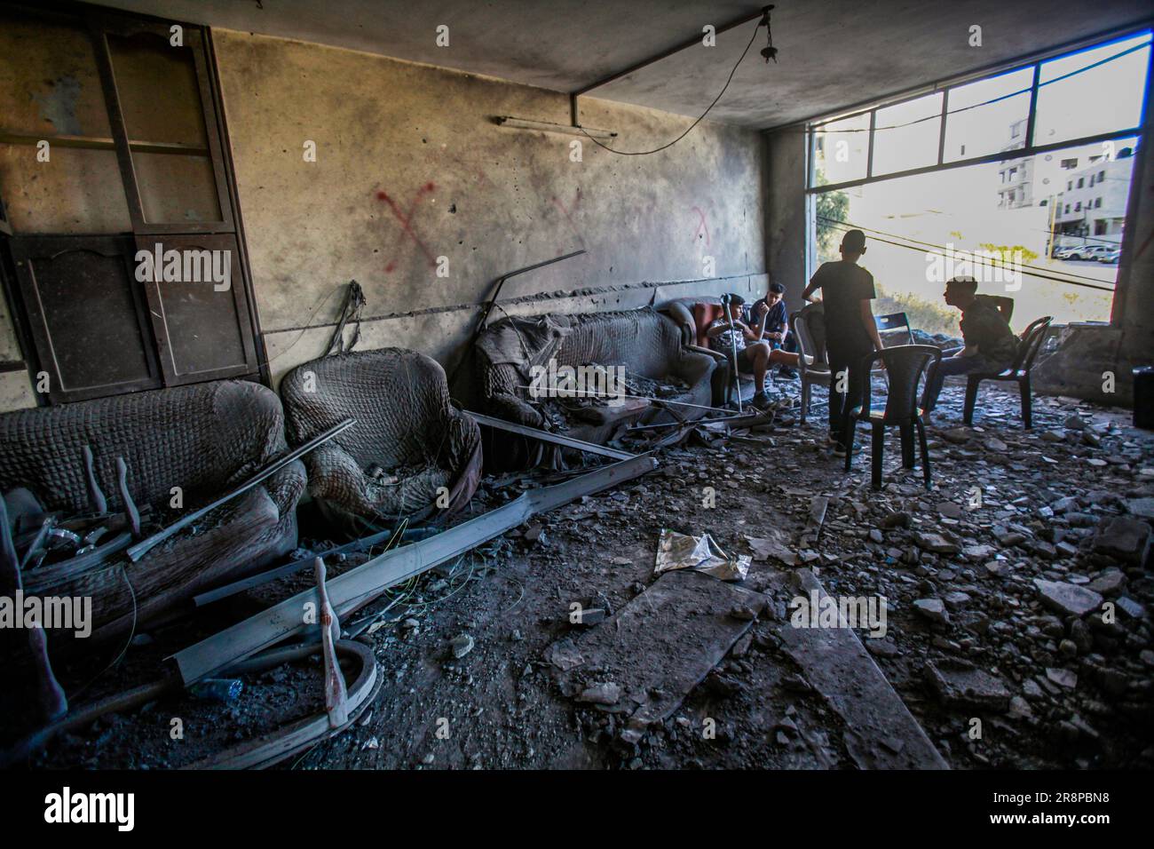 Palestinians inspect a destroyed house of the Palestinian imprisoned ...