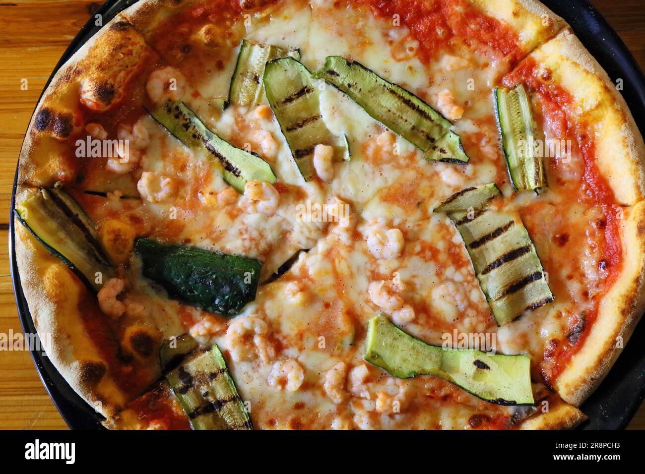 Italian pizza freshly served in a restaurant in Sardinia island in ...