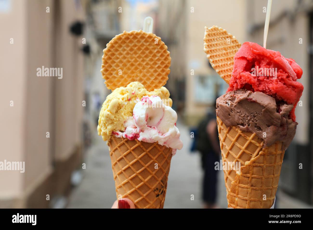 Ice cream in Alghero, Sardinia. Hand holding Italian gelato ice cream ...
