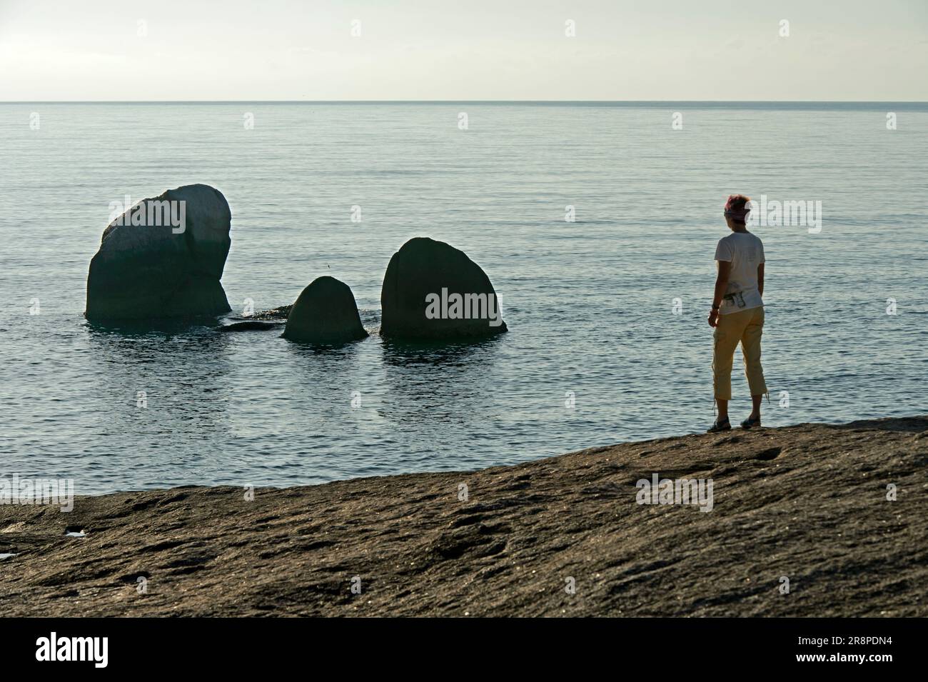 Dusk at Lamai Beach with person and rocky cliffs in the sea, Koh Samui ...