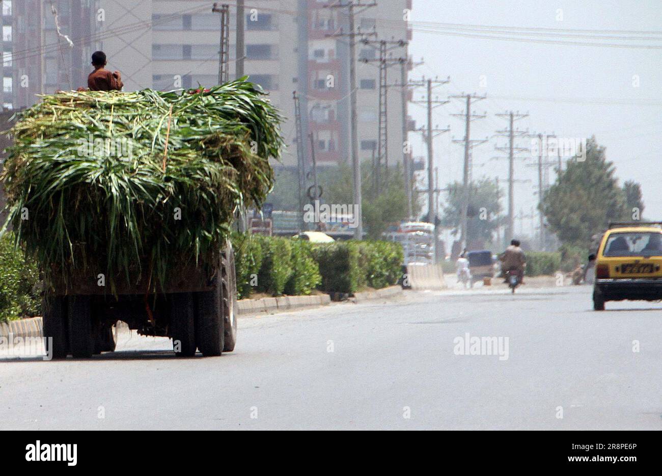 Hyderabad, Pakistan, June 22, 2023. An overloaded tractor trolley with ...