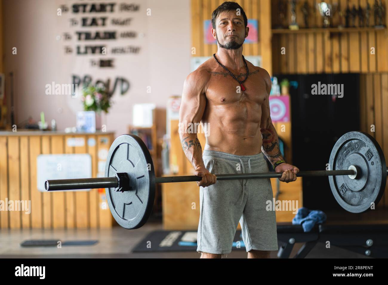 Photo with copy space of a strong man doing weights with a bar Stock ...