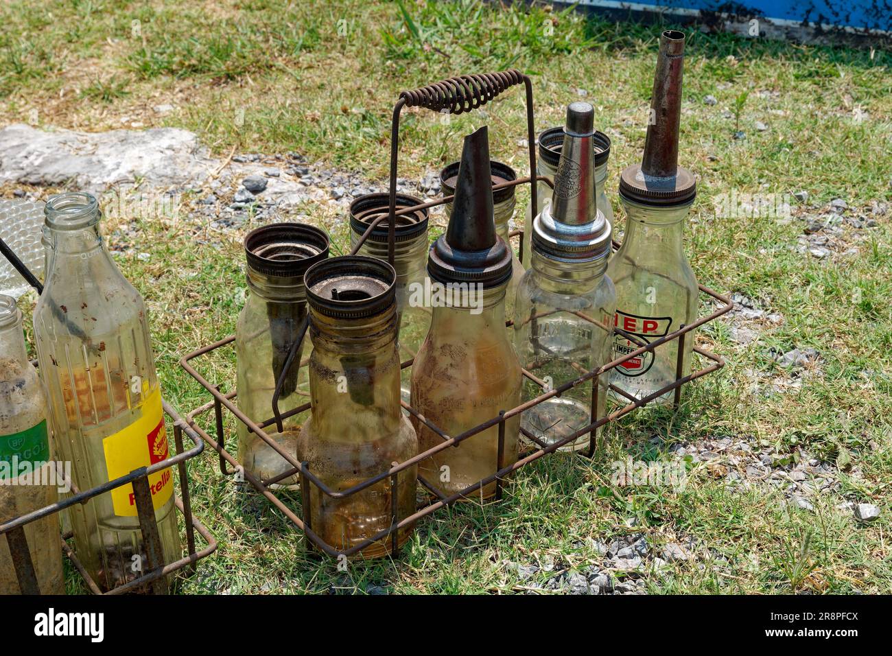 A collection of various used antique petroleum oil glass bottles in a ...