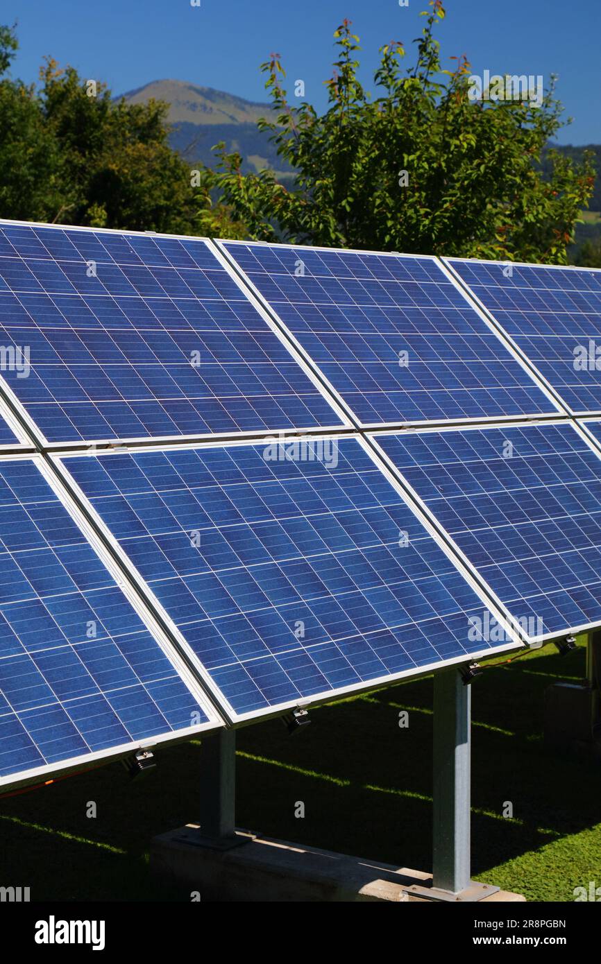 Solar panels mounted on frame in the yard next to a private home ...