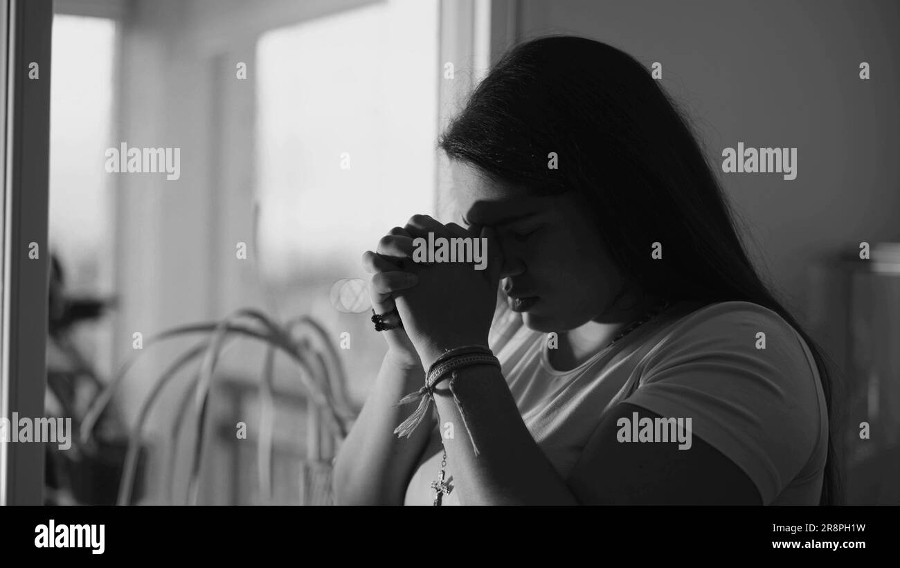 Spiritual Young Woman Praying to God, Hands Clenched in Dramatic Black ...