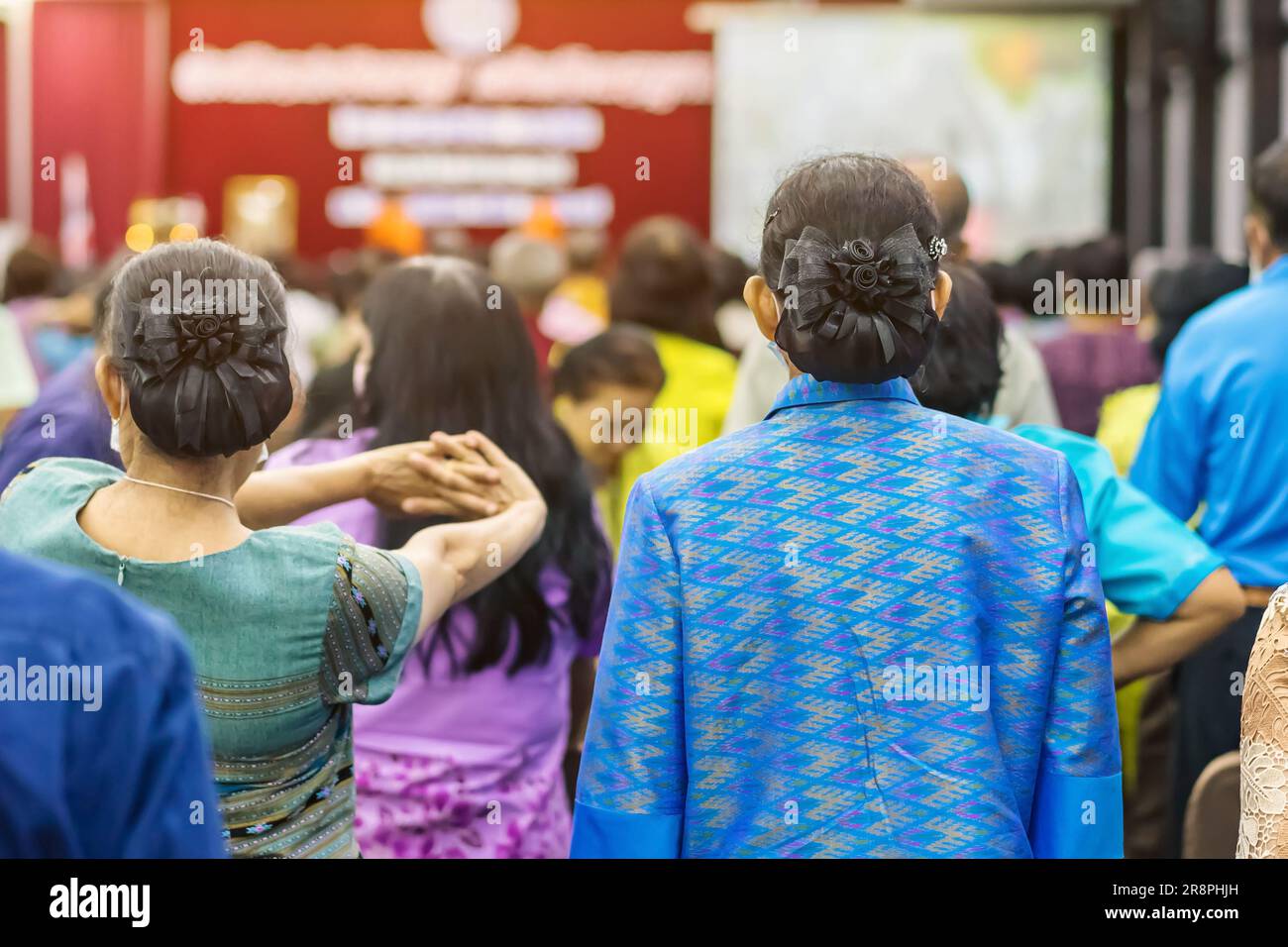 Back view of senior woman wear face mask attending and listening to the ...