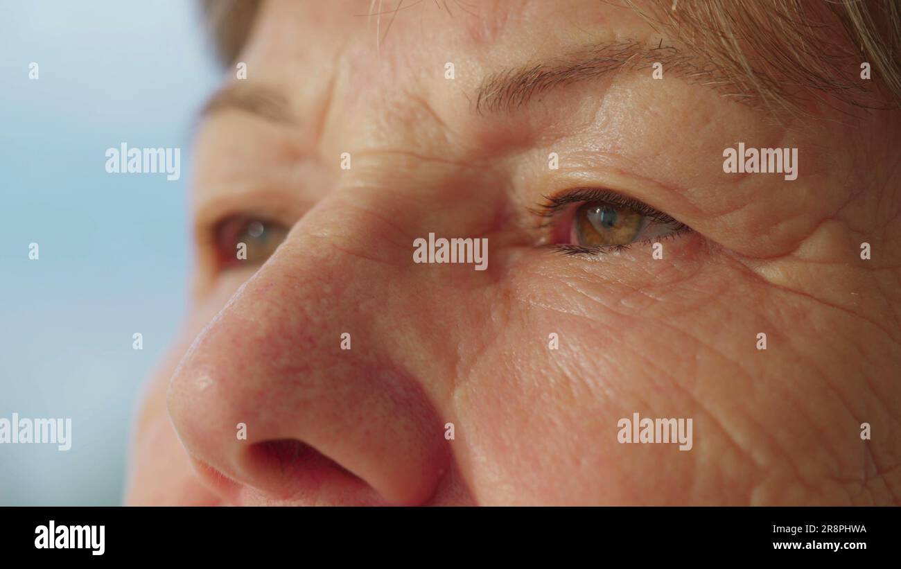Pensive senior woman close-up eyes in deep reflection. Contemplative ...