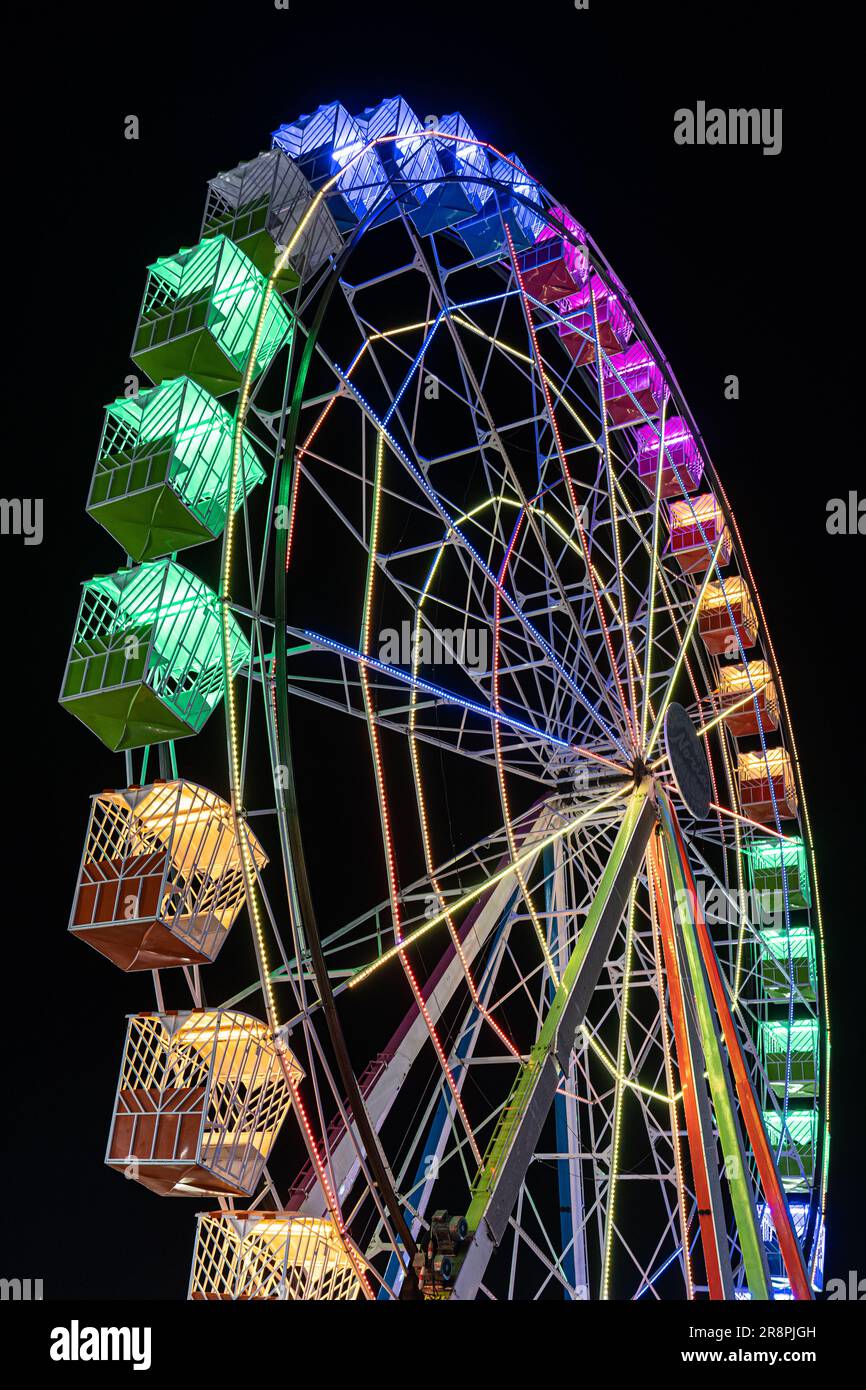 A vibrant and towering ferris wheel captures the attention with its ...