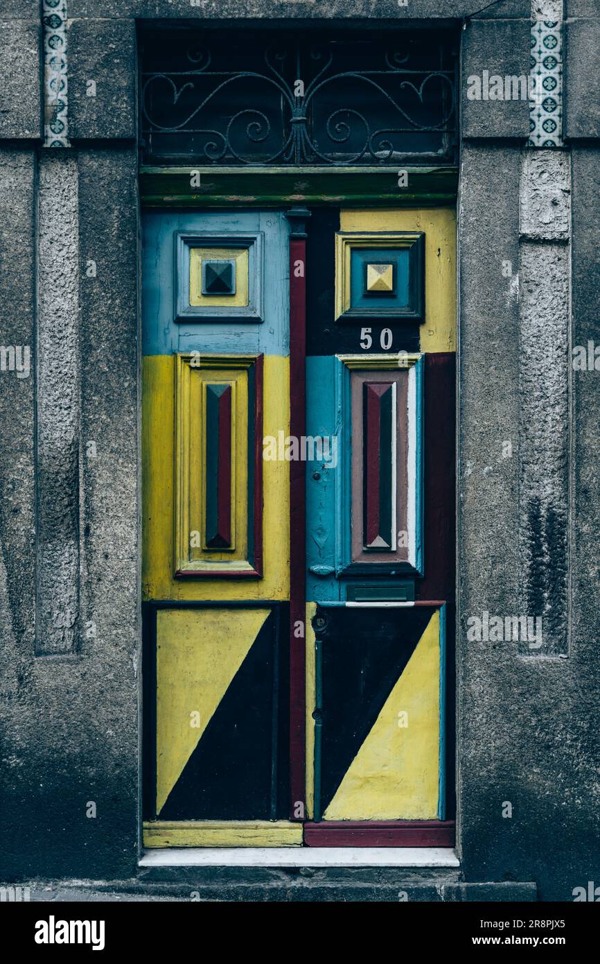 A vibrant, weathered door bursts with an array of colors, telling ...