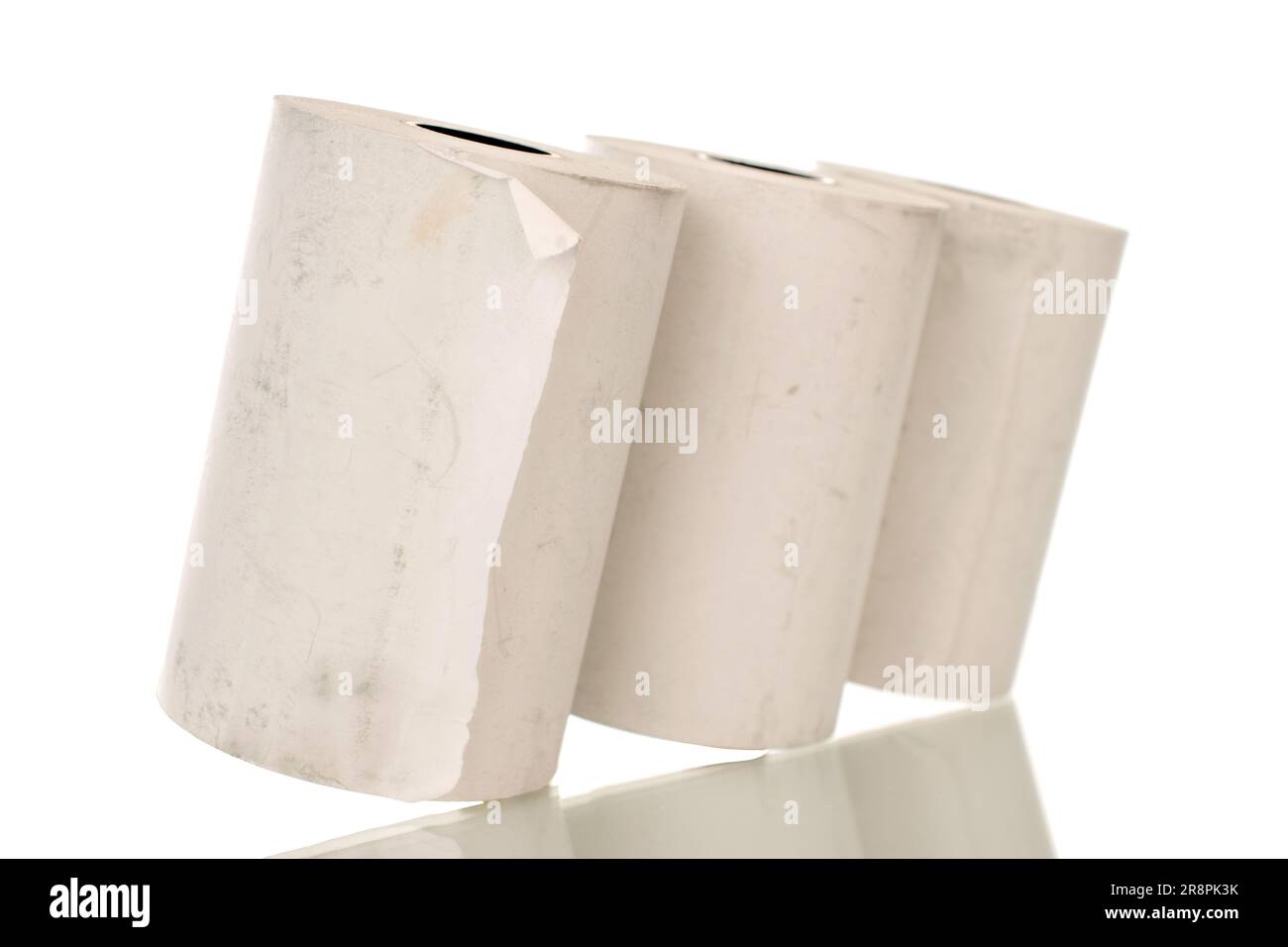 Three rolls of paper cash register tape, close-up isolated on white ...