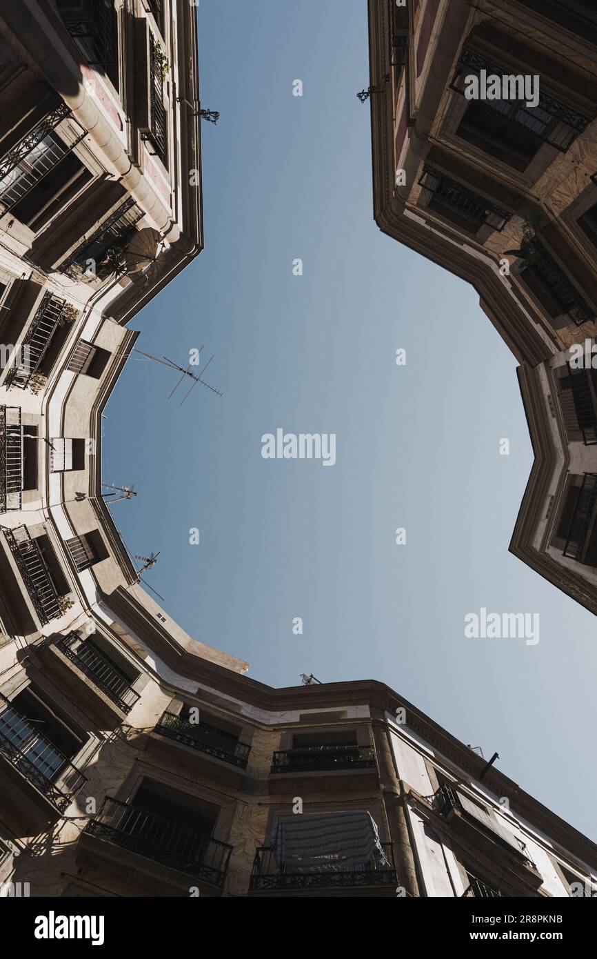 The towering buildings of Barcelona frame the clear sky creating a ...