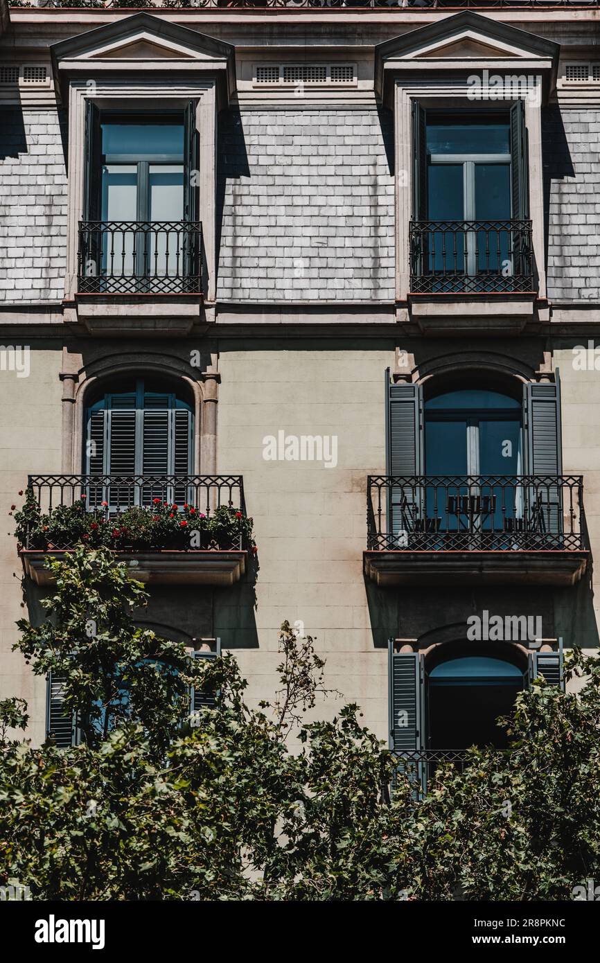 The pastel-colored facade of a building in Barcelona adds a touch of ...