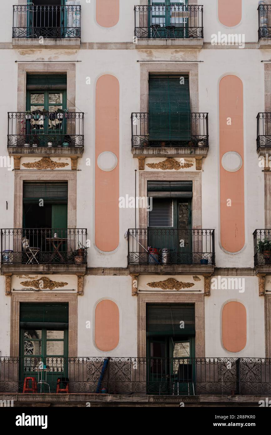 The pastel-colored facade of a building in Barcelona adds a touch of ...