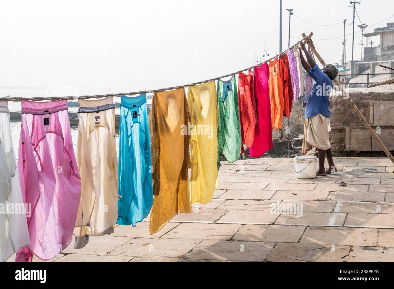 A dhobi hangs a rainbow of clothes to dry on the ghats of Varanasi ...