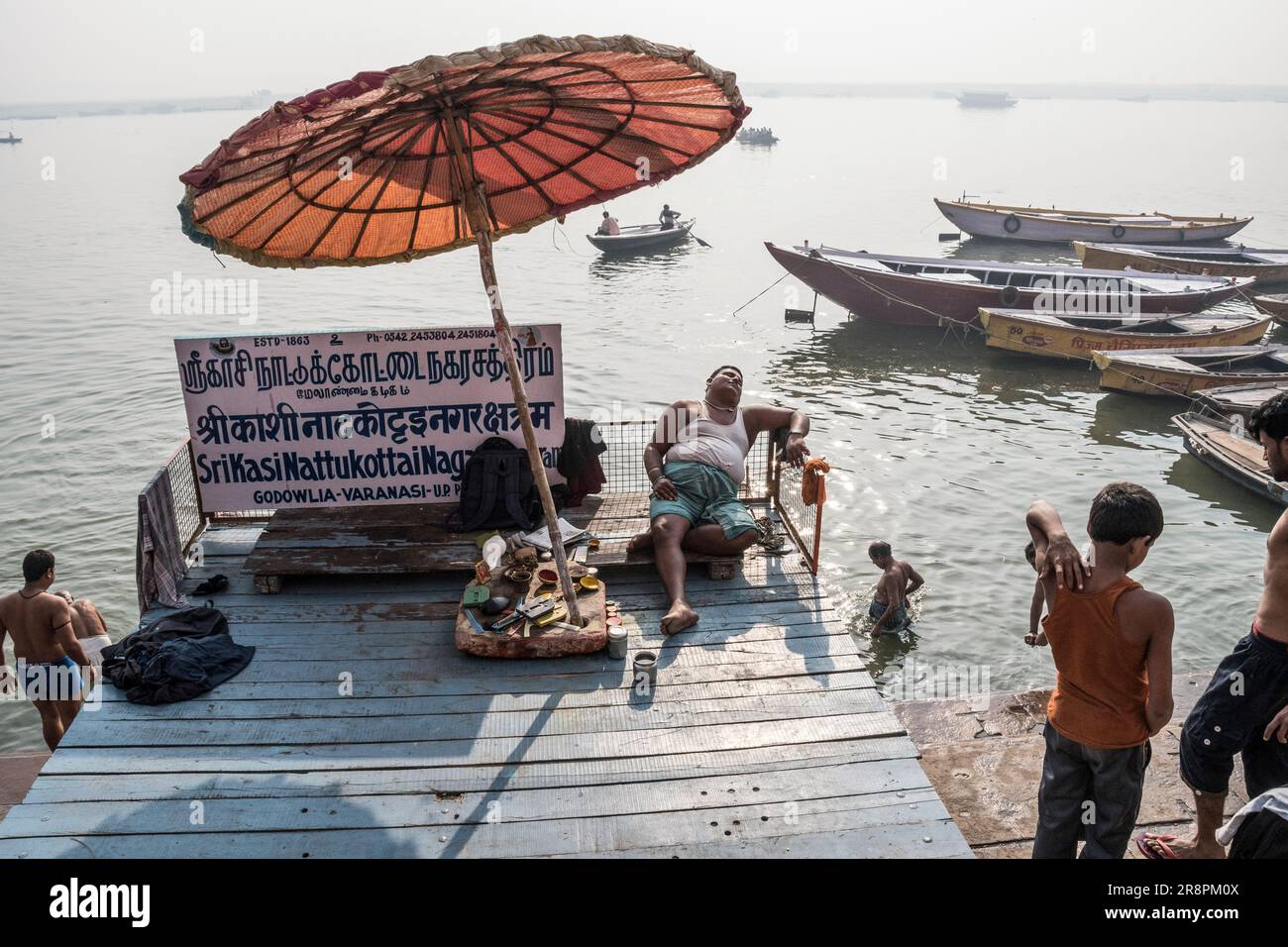 A pandit takes a nap on the ghats of Varanasi, India Stock Photo - Alamy