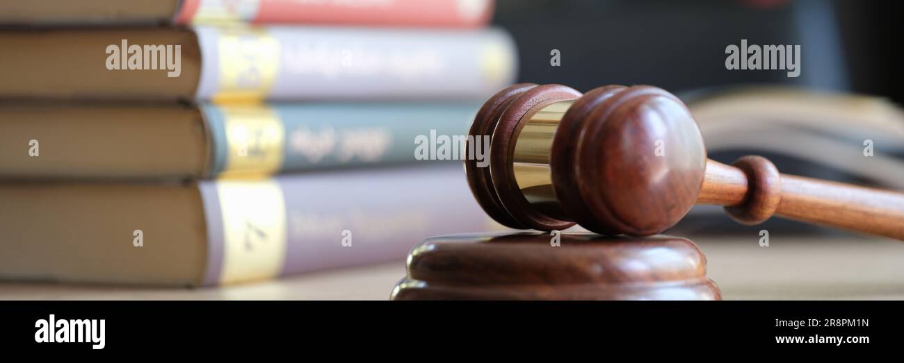 Judge gavel on wooden sounding block and pile of law books Stock Photo ...