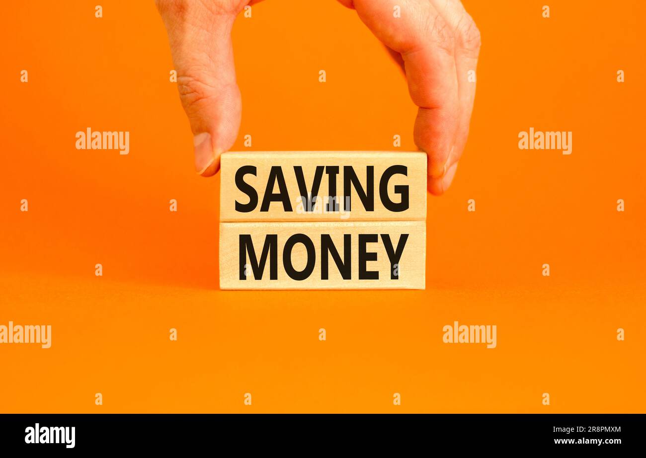 Saving money symbol. Concept words Saving money on wooden blocks on a ...