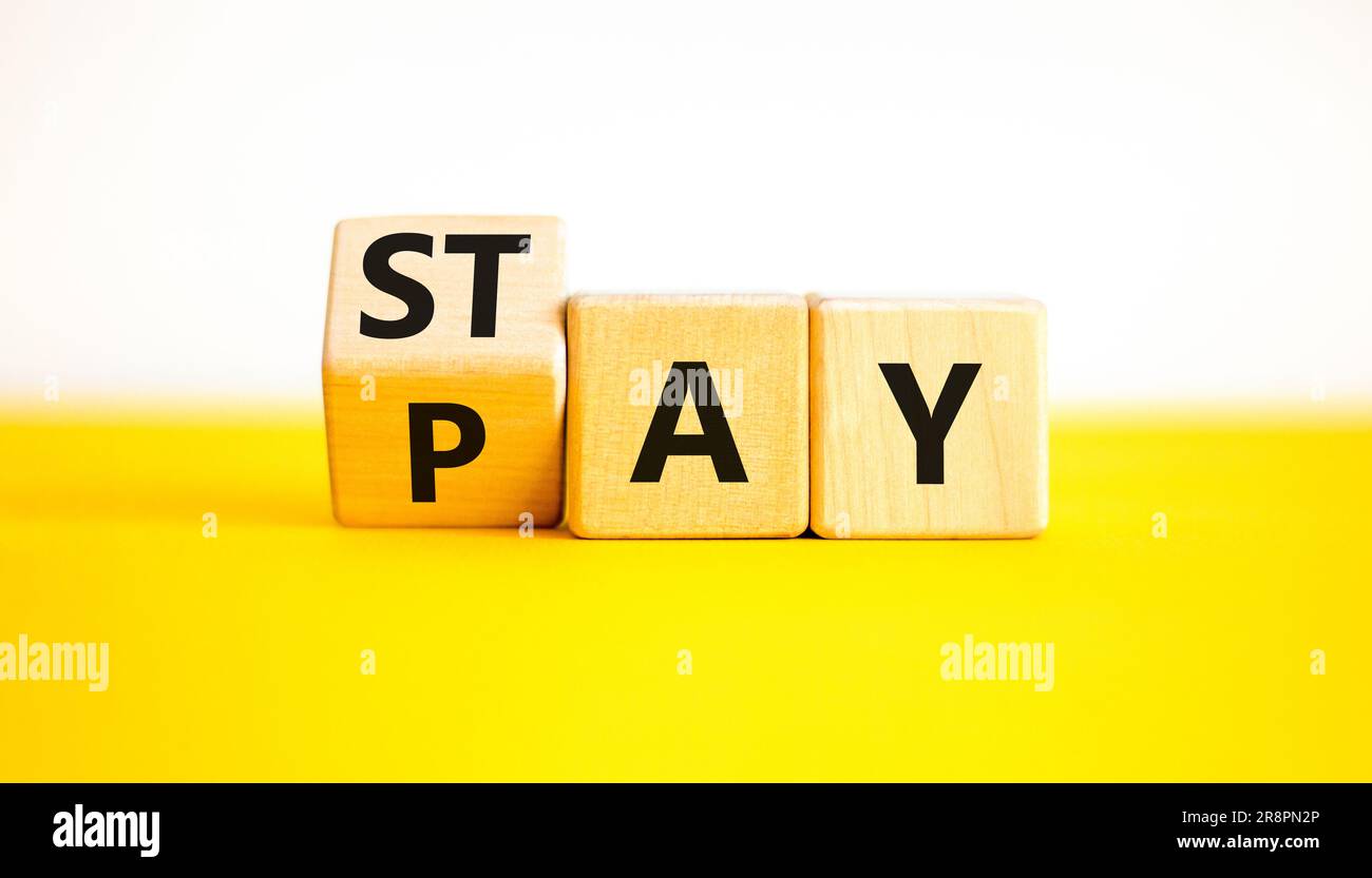 Stay and pay symbol. Businessman turns wooden cubes and changes the ...