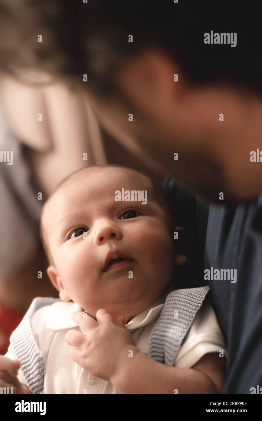 A baby's innocent face gazes directly into the loving eyes of their ...