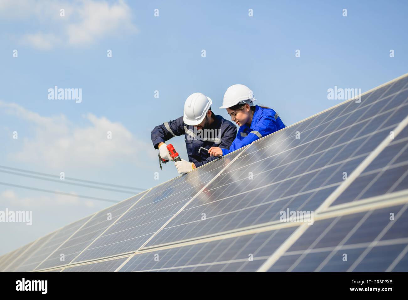 Technicians workers installing solar panels at solar cell farm Stock ...