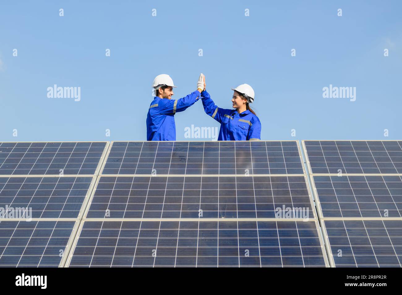 Technicians workers installing solar panels at solar cell farm Stock ...