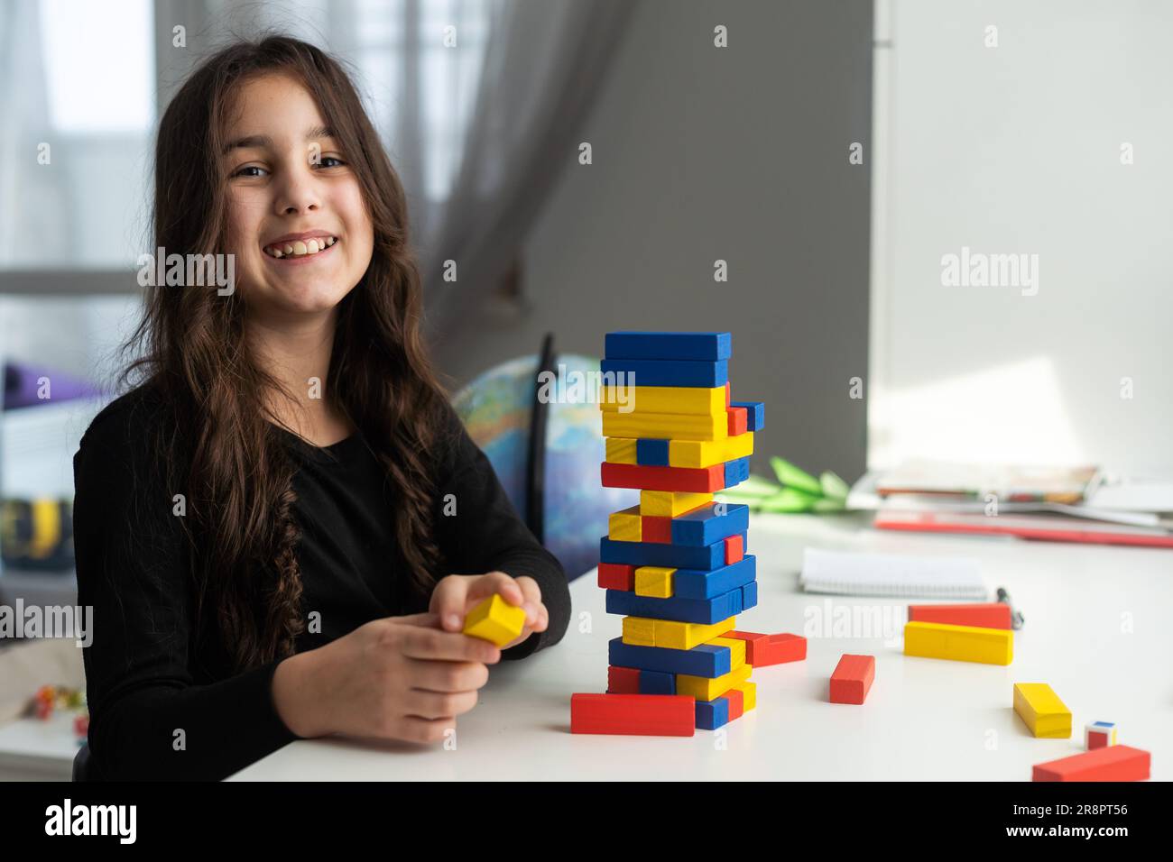 Children building wood blocks at playground. Girl kid playing stacking ...