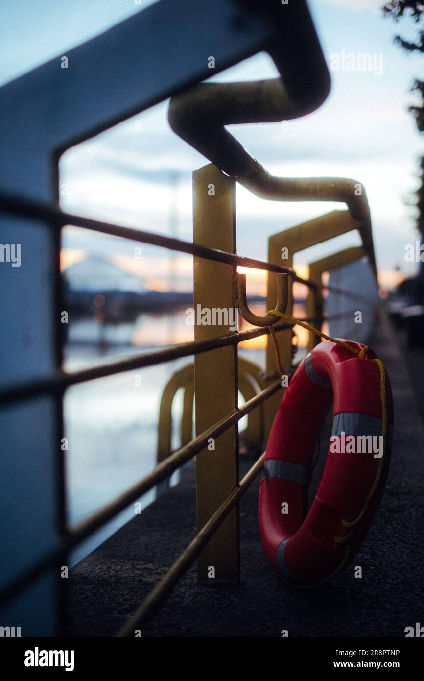 A metal safety ring attached firmly to the handrail of a staircase ...