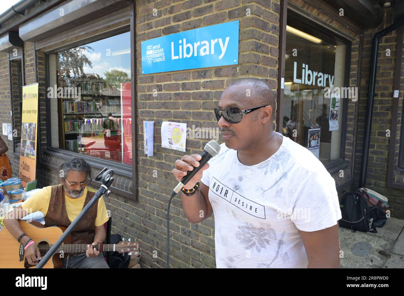 A black vocalist singing outside Broadfield Library Stock Photo - Alamy