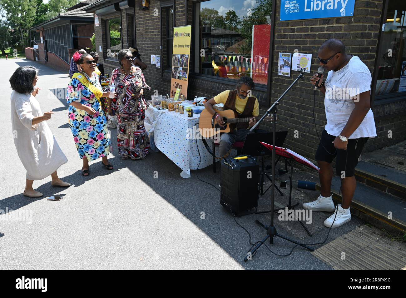 A black vocalist singing outside Broadfield Library Stock Photo - Alamy
