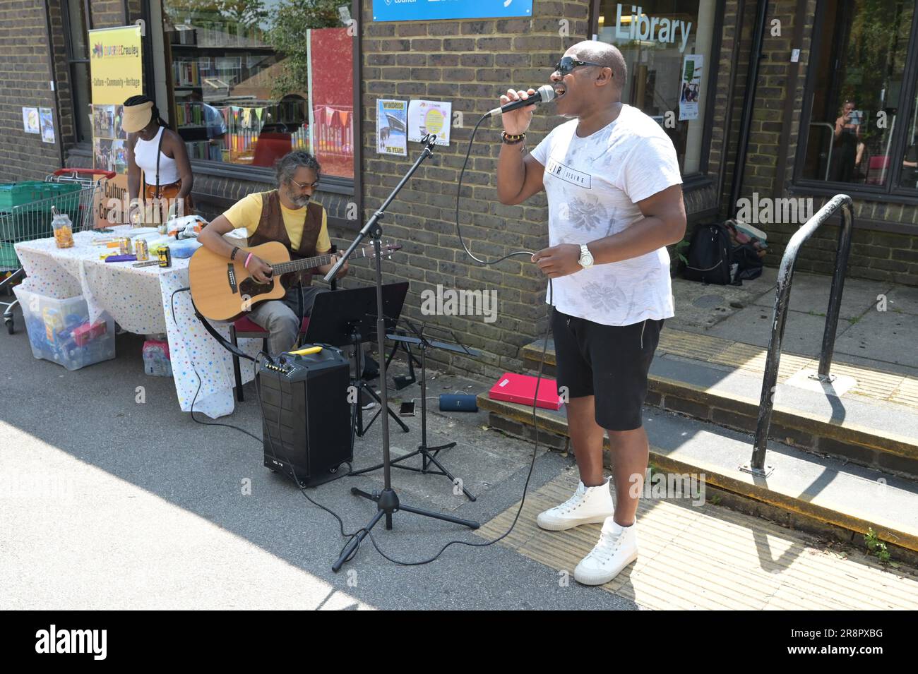 A black vocalist singing outside Broadfield Library Stock Photo - Alamy