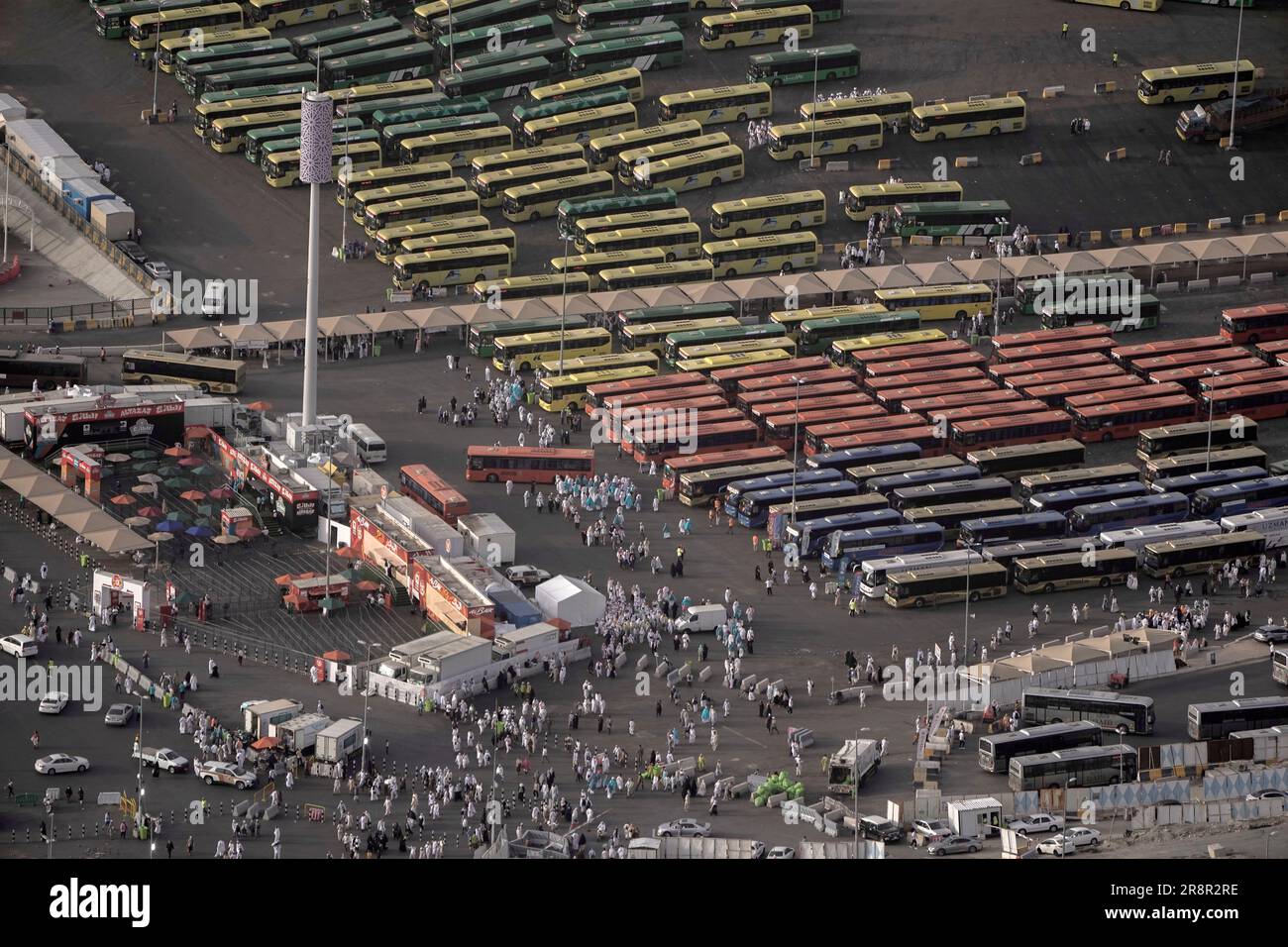 Dozens of buses park as pilgrims walk to enter the Grand Mosque, during ...