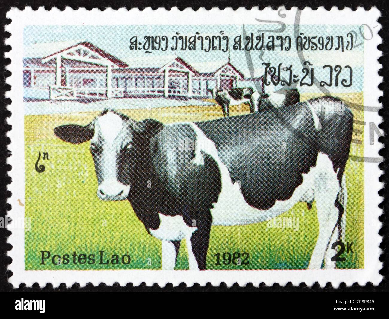 LAOS - CIRCA 1982: a stamp printed in Laos shows cows and farm, 7th ...