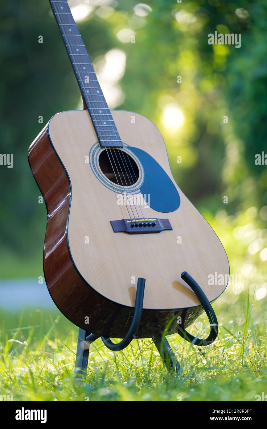 Acoustic guitar outdoors on greenery background. Concept of calm music ...